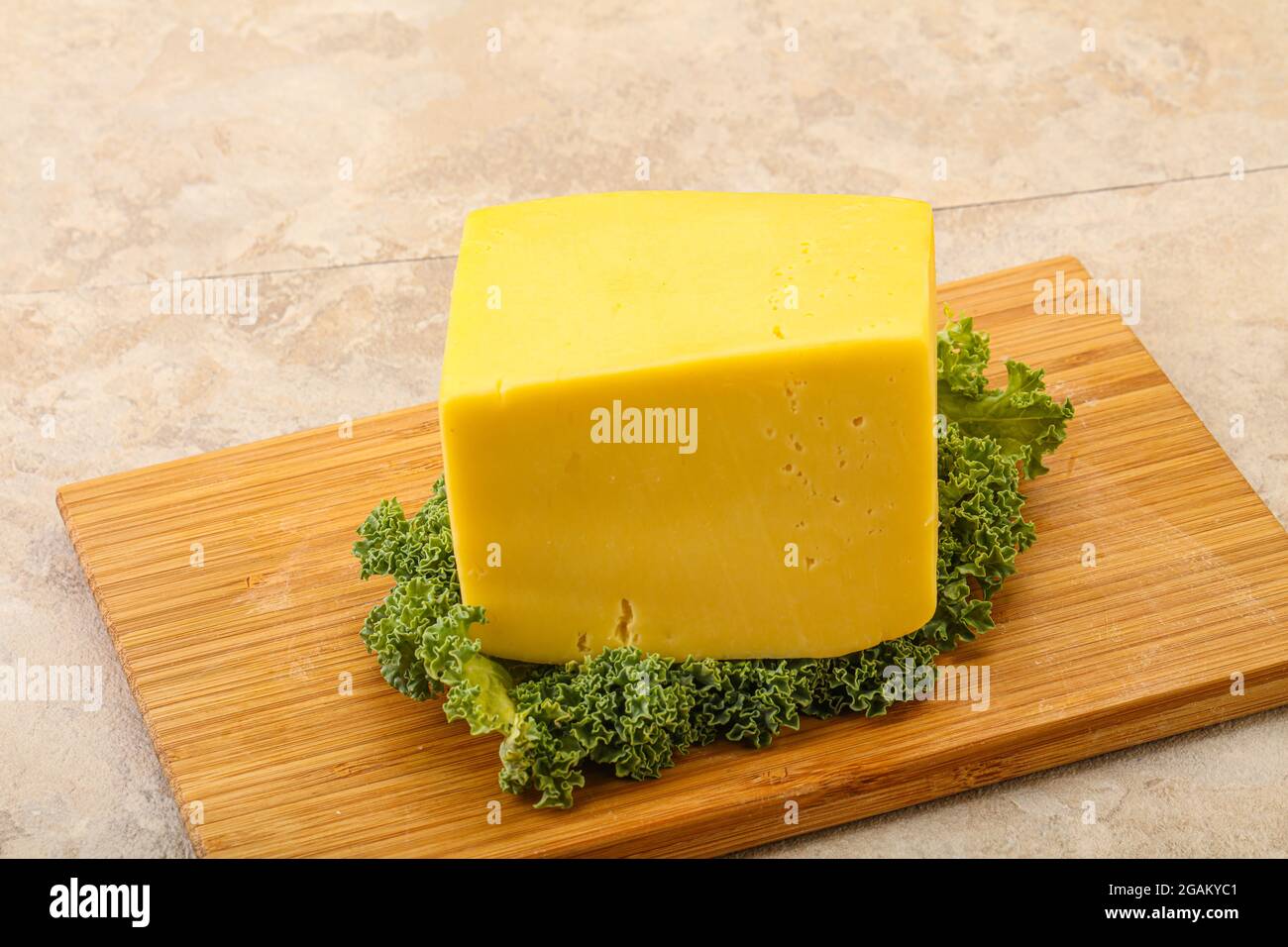 Yellow tilsiter cheese dairy product brick Stock Photo - Alamy