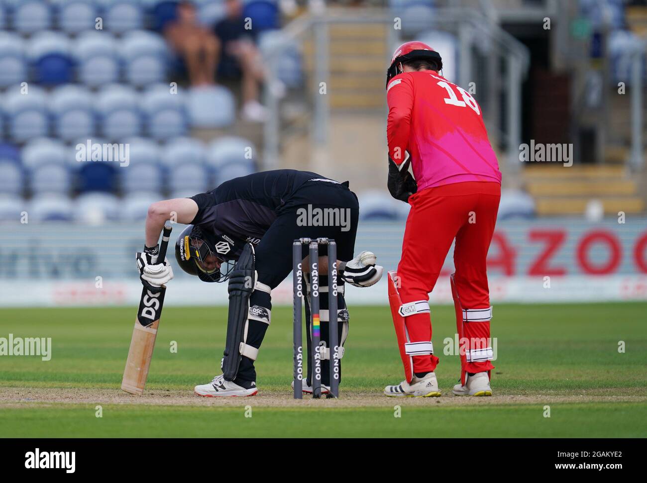 Manchester Originals' Colin Munro hands the ball to Welsh Fire Tom ...