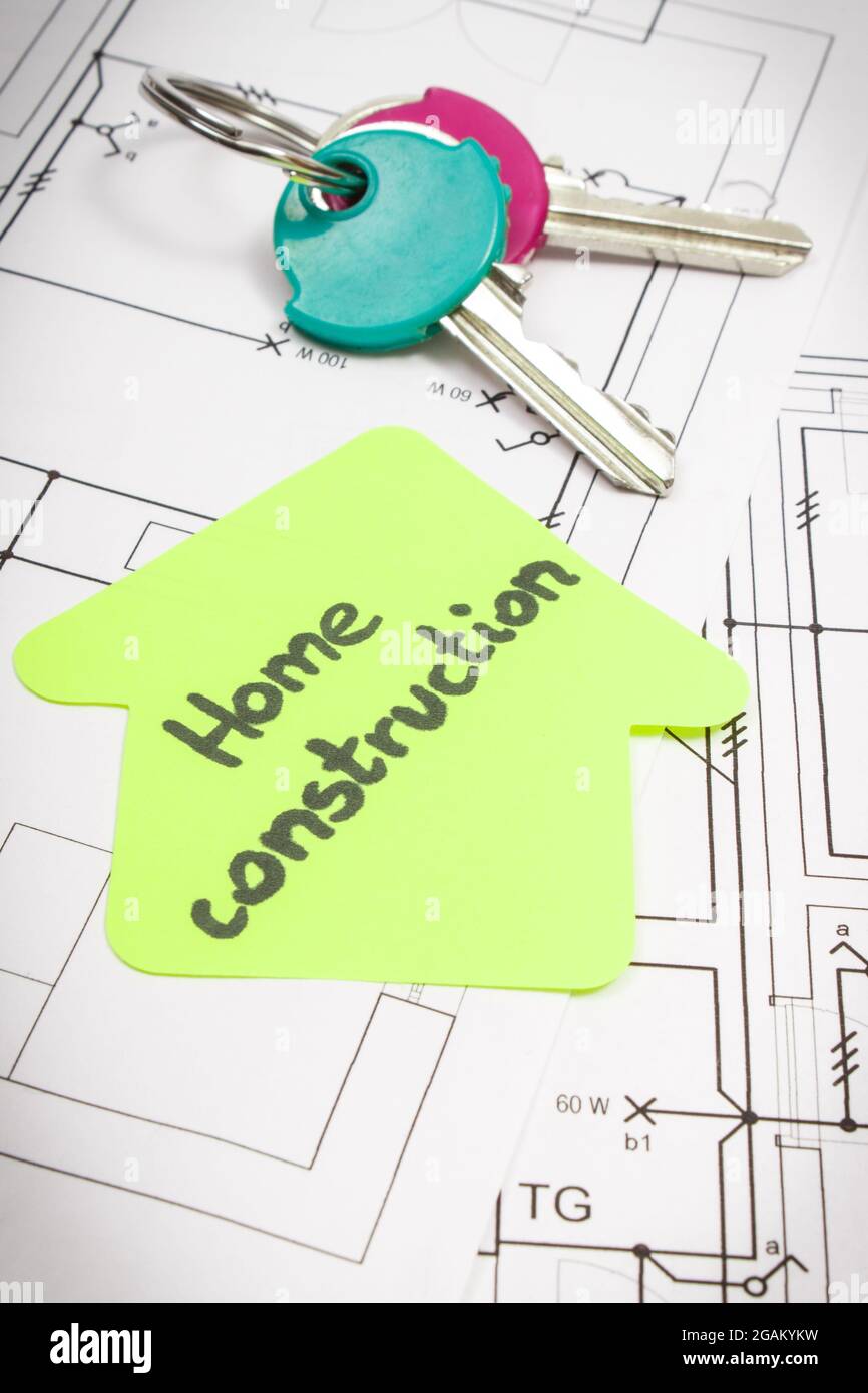 House shape made of paper, home keys and diagrams of plan with ...