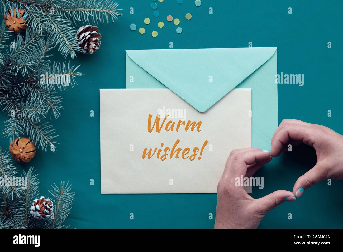 Greeting Warm Wishes on postcard with envelope. Hands show heart sign ...
