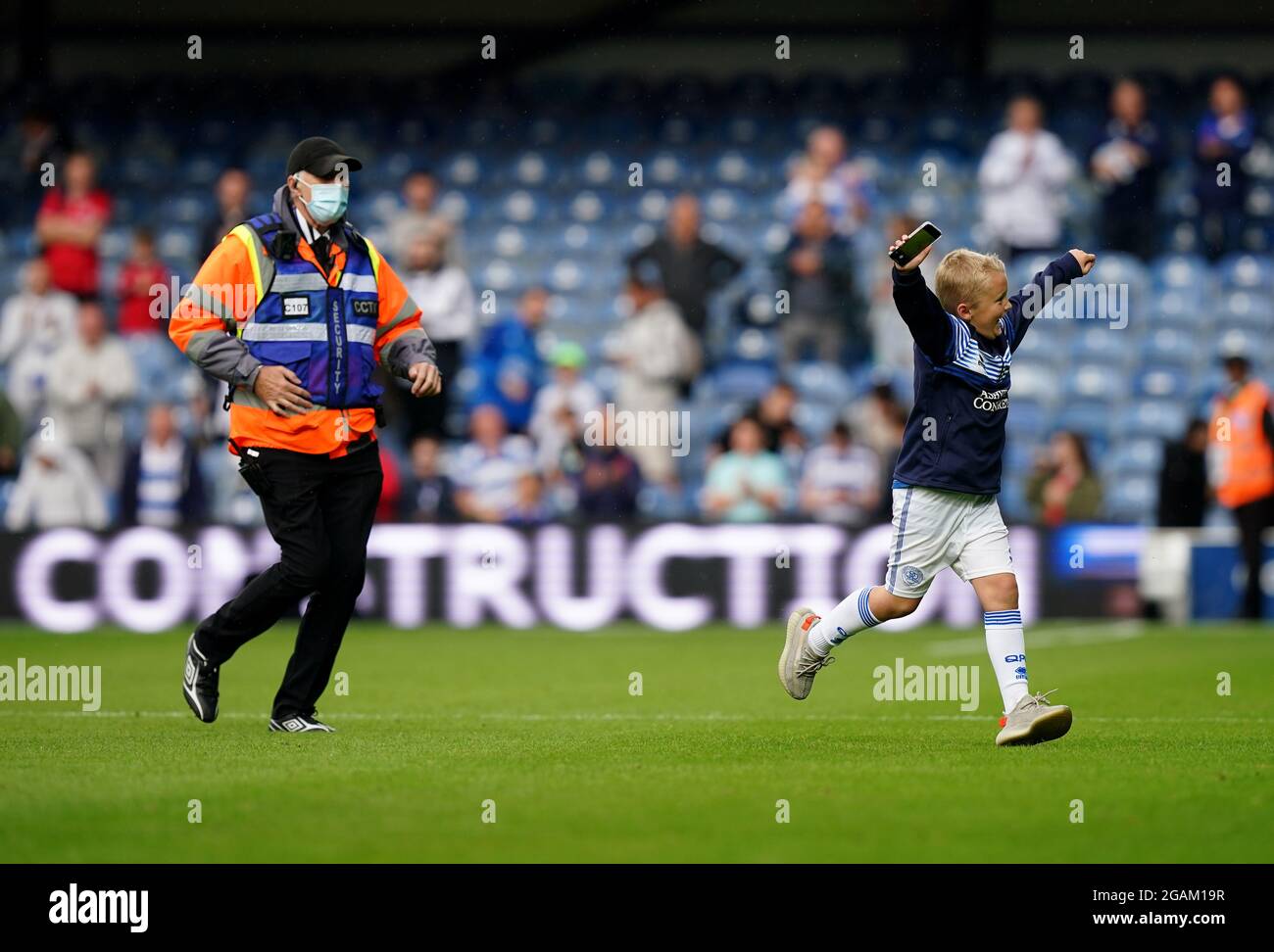 A young fan invades the pitch after the pre-season friendly match at ...