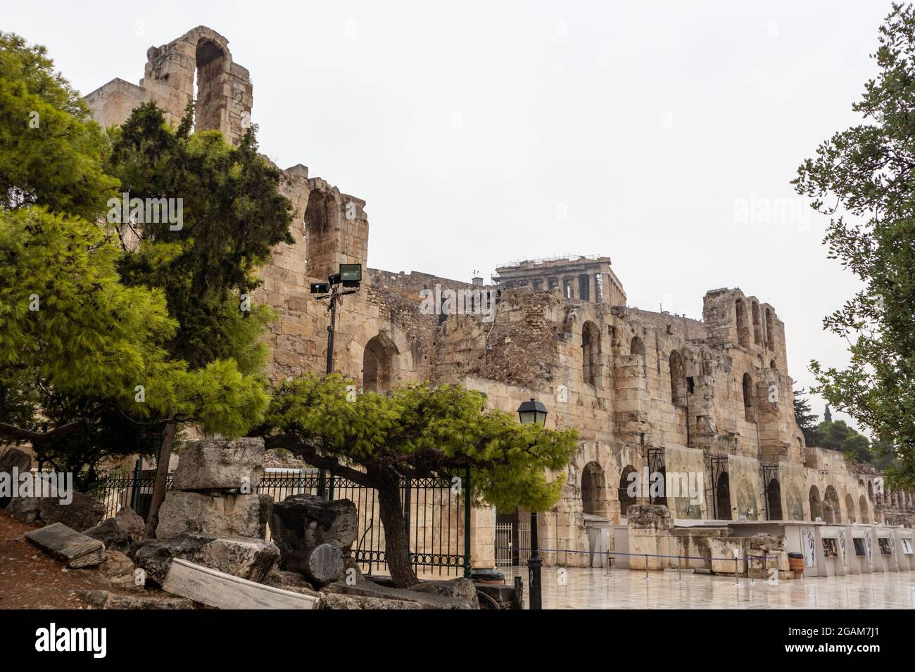 Entrance square to Odeon of Herodes Atticus in green pine trees on ...
