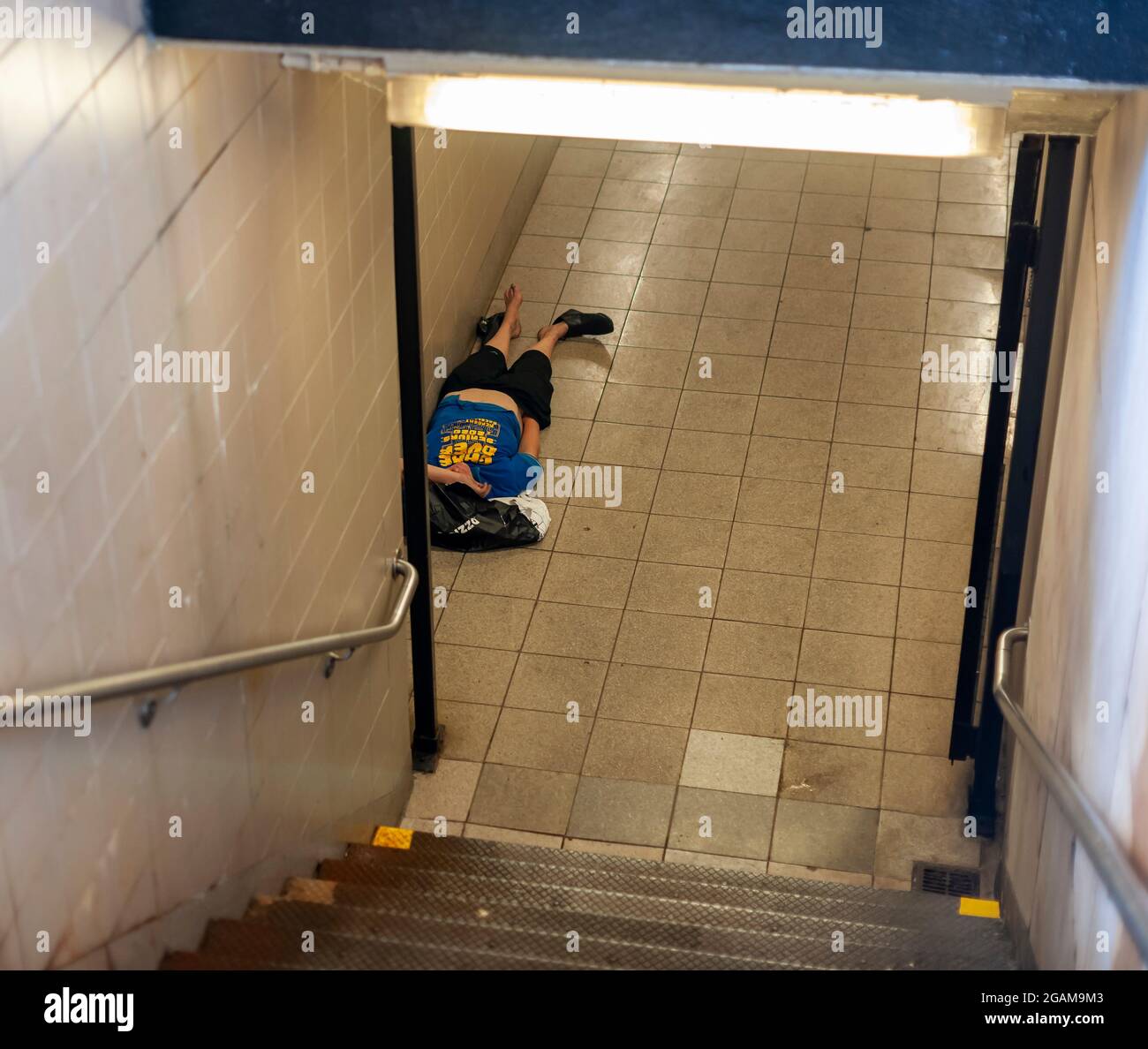 Homeless man sleeping in subway hi-res stock photography and images - Alamy