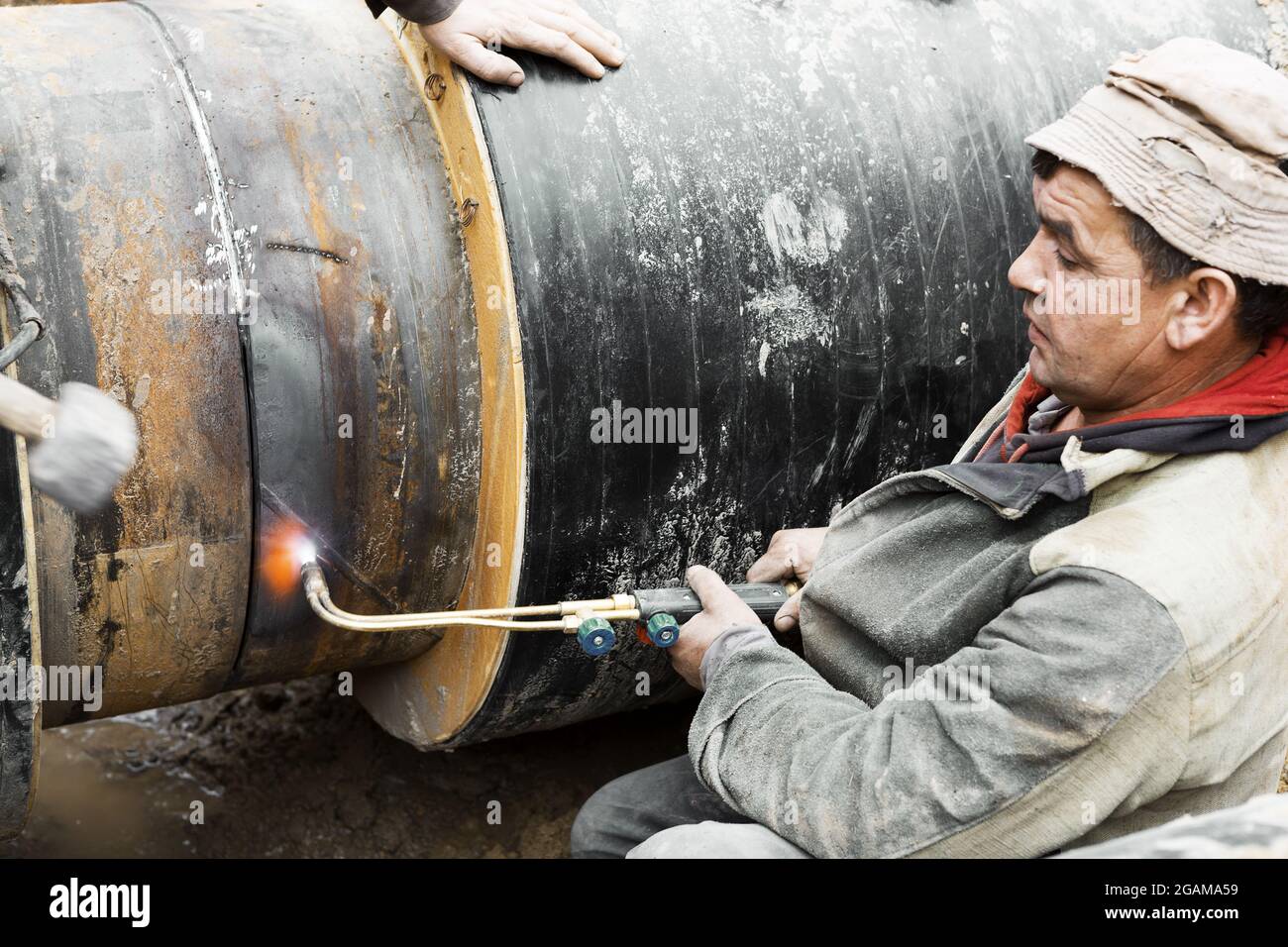 Odessa, Ukraine - October 11, 2016: Repair of heating duct. The workers ...