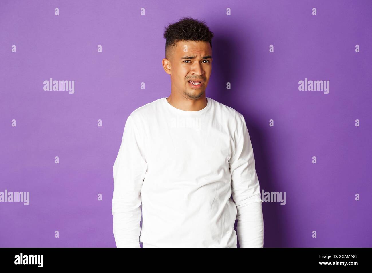 Portrait of disgusted young african-american guy, cringe from aversion ...