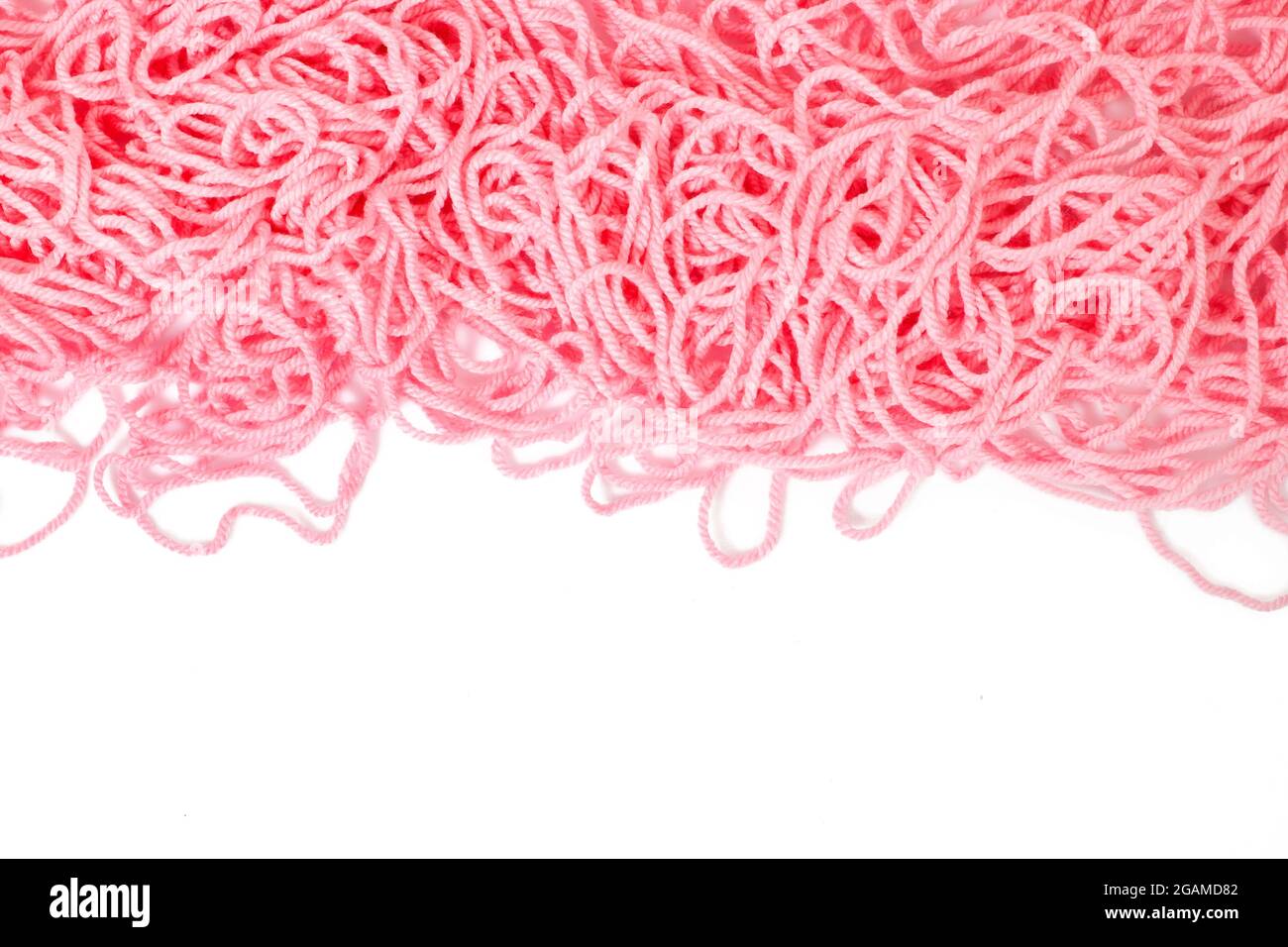 Pile of a pink tangled knitting yarn of wool Stock Photo - Alamy