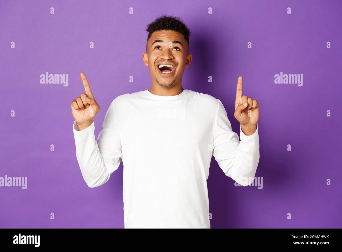 Handsome excited african-american guy, wearing white sweatshirt ...