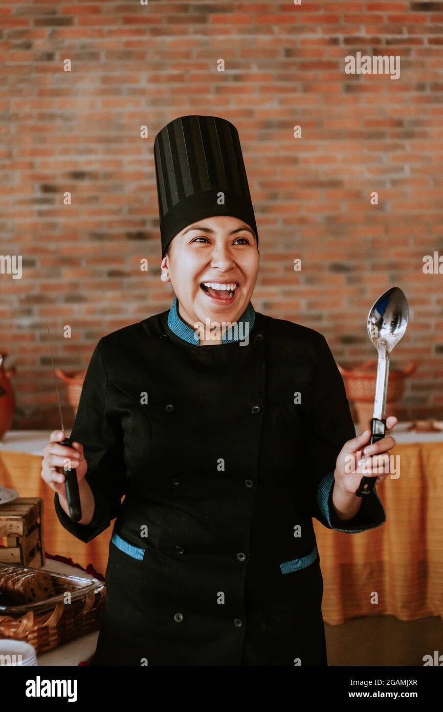 Portrait of latin female chef smiling in mexican restaurant Stock Photo ...