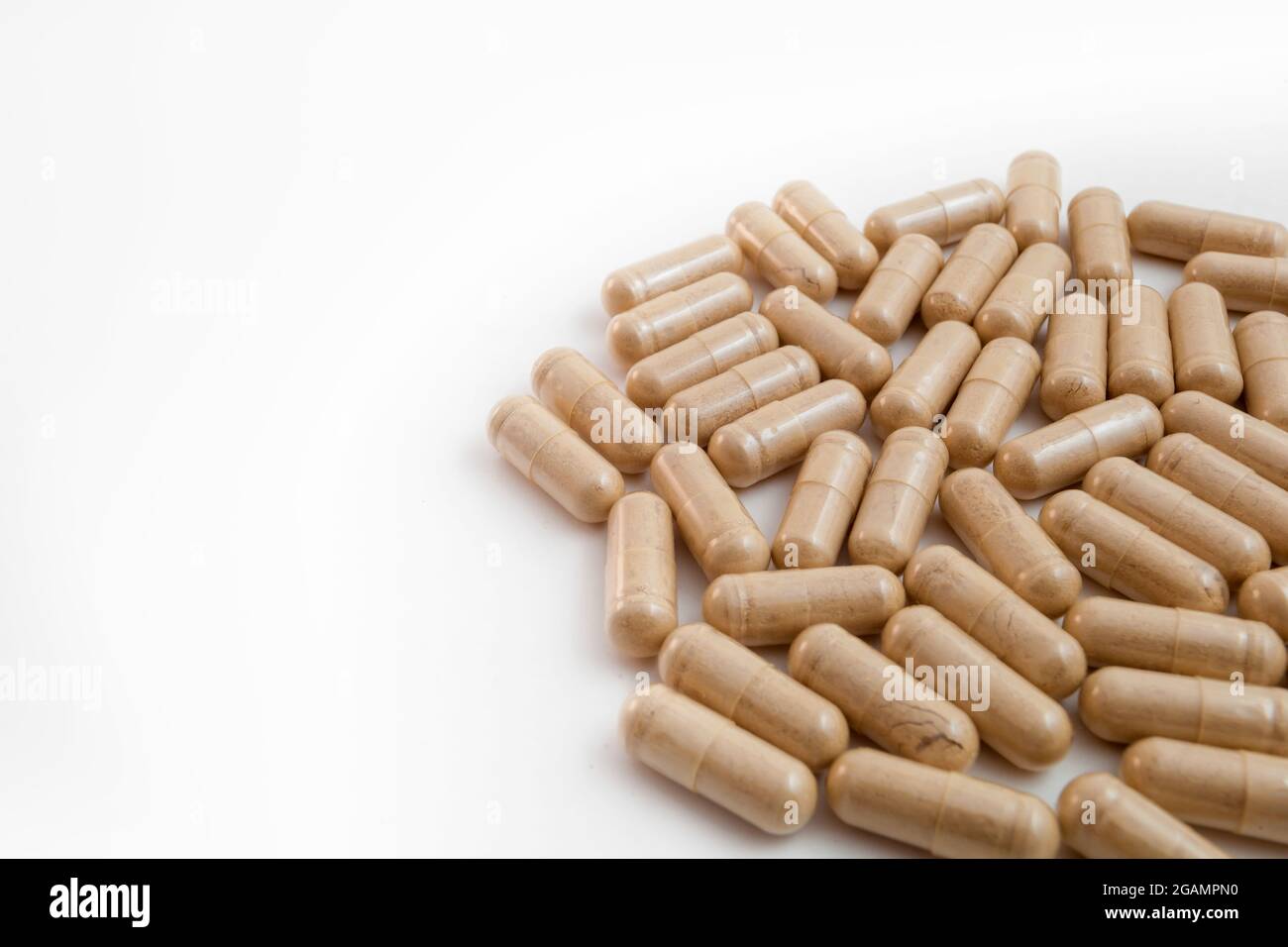 Brown capsule pills on white isolated background Stock Photo - Alamy