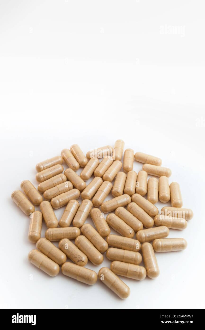 Brown capsule pills on white isolated background Stock Photo - Alamy