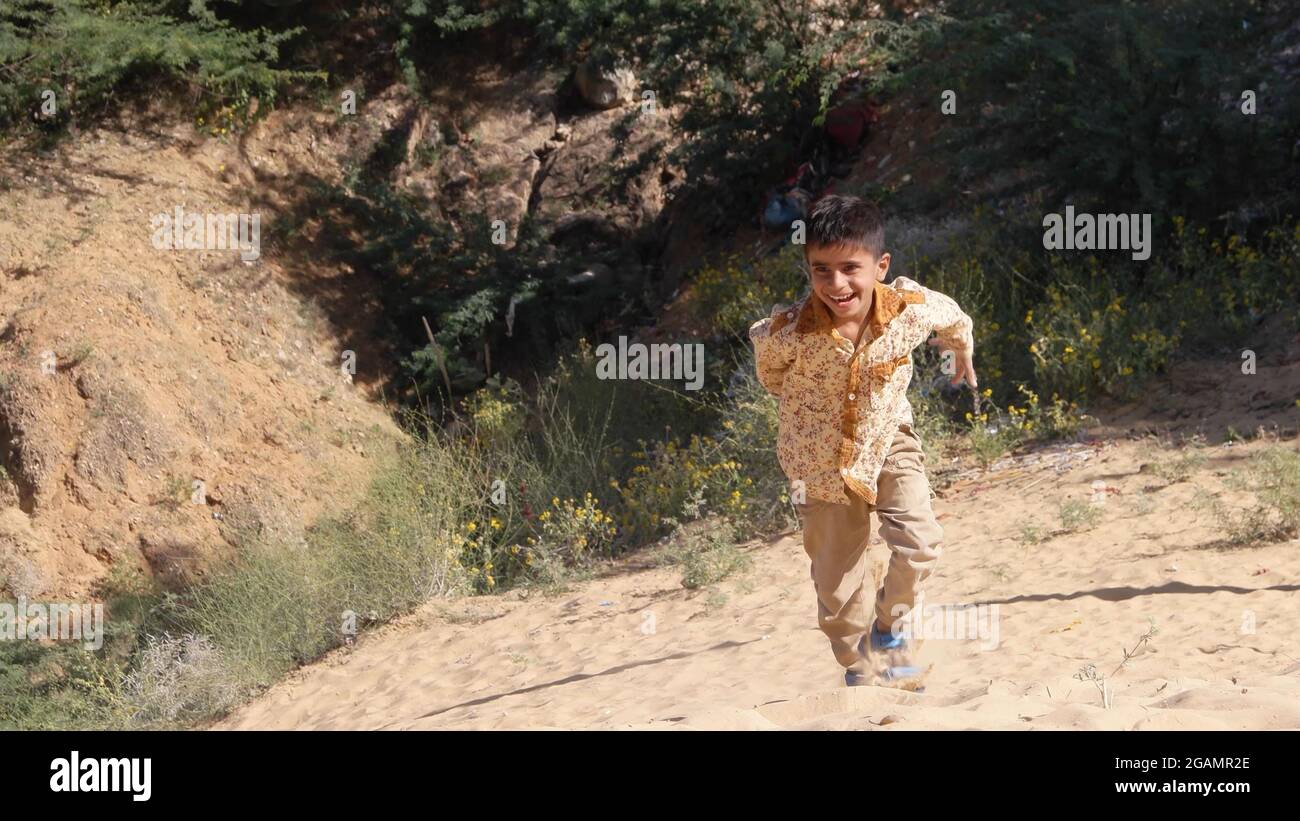 Indian male kid running and having fun Stock Photo - Alamy
