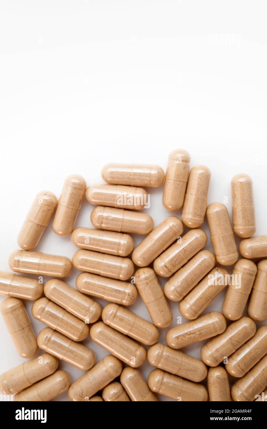 Brown capsule pills on white isolated background Stock Photo - Alamy