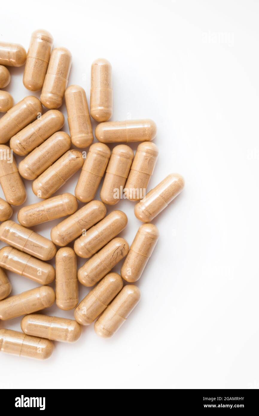 Brown capsule pills on white isolated background Stock Photo - Alamy