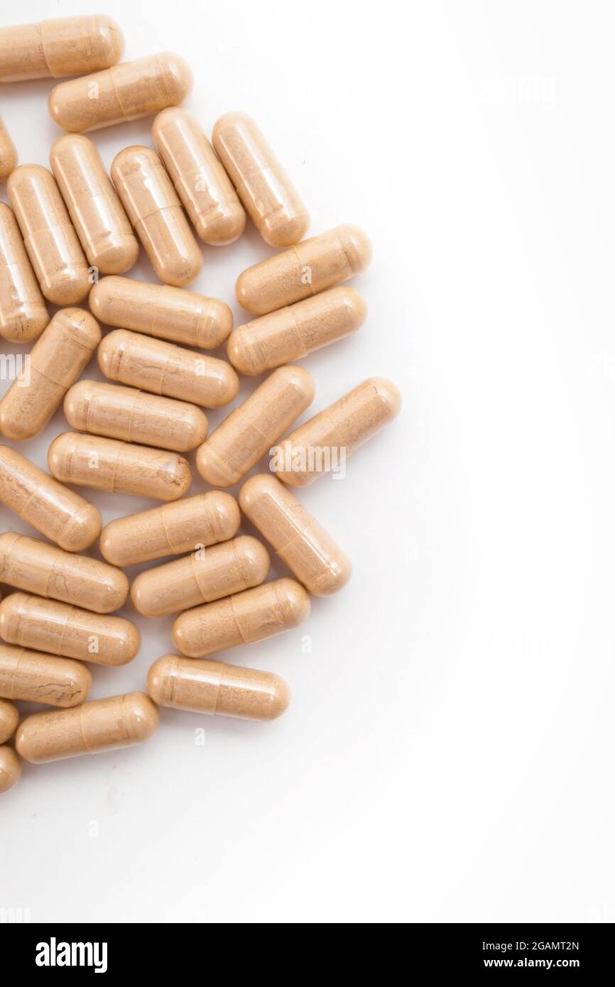 Brown capsule pills on white isolated background Stock Photo - Alamy