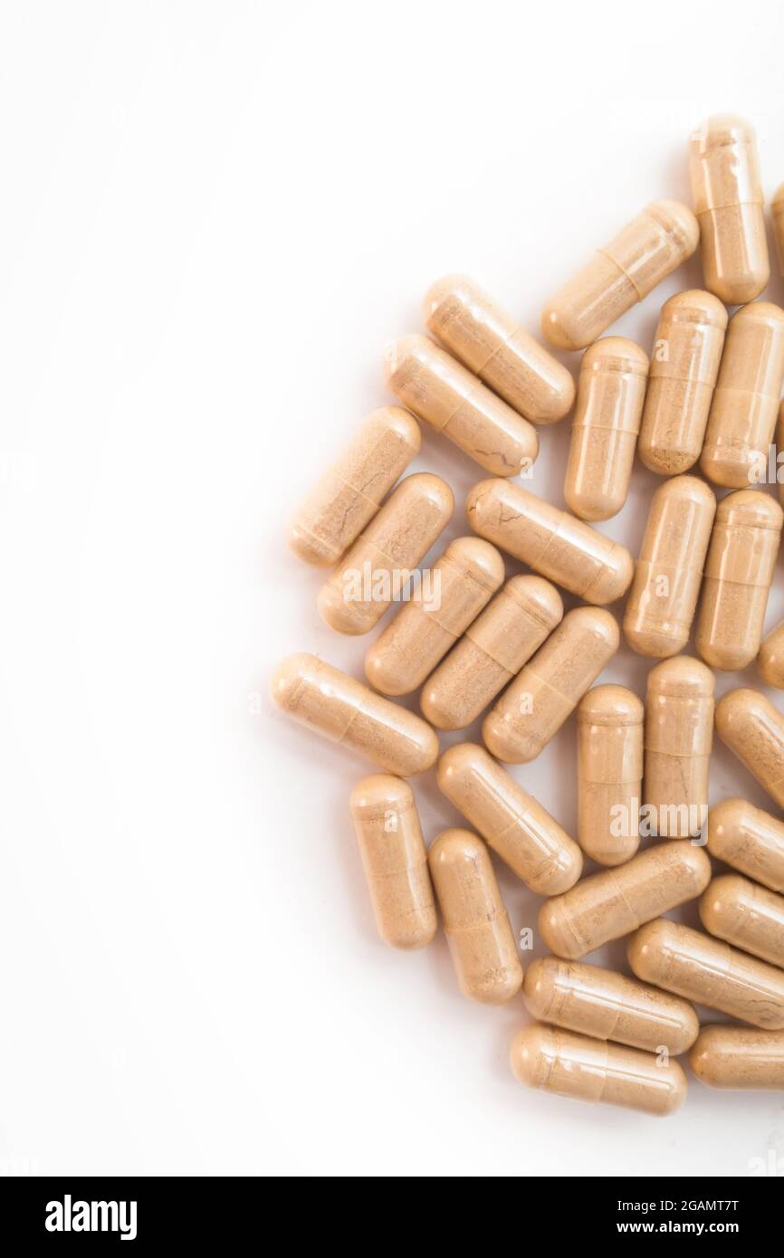 Brown capsule pills on white isolated background Stock Photo - Alamy