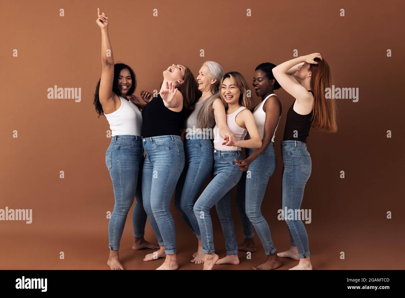 Side view of women of different body types dancing together and having ...
