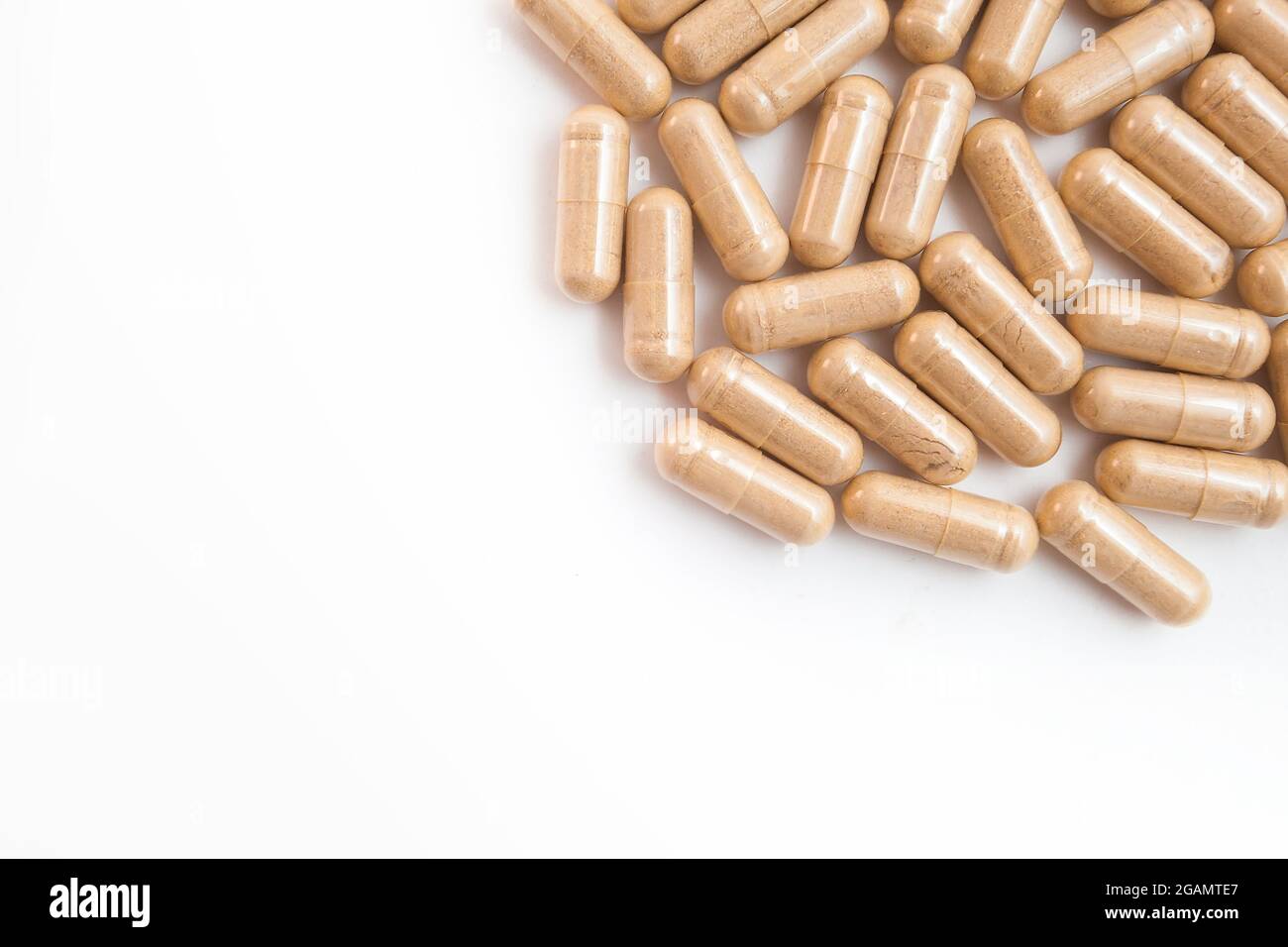 Brown capsule pills on white isolated background Stock Photo - Alamy