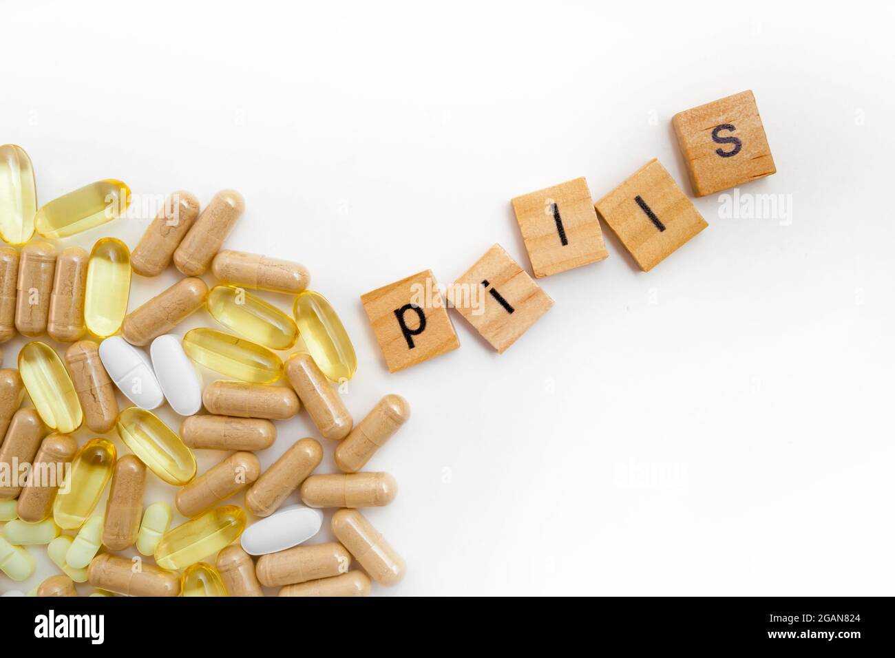 inscription PILLS in wooden cubes on a white background of different ...