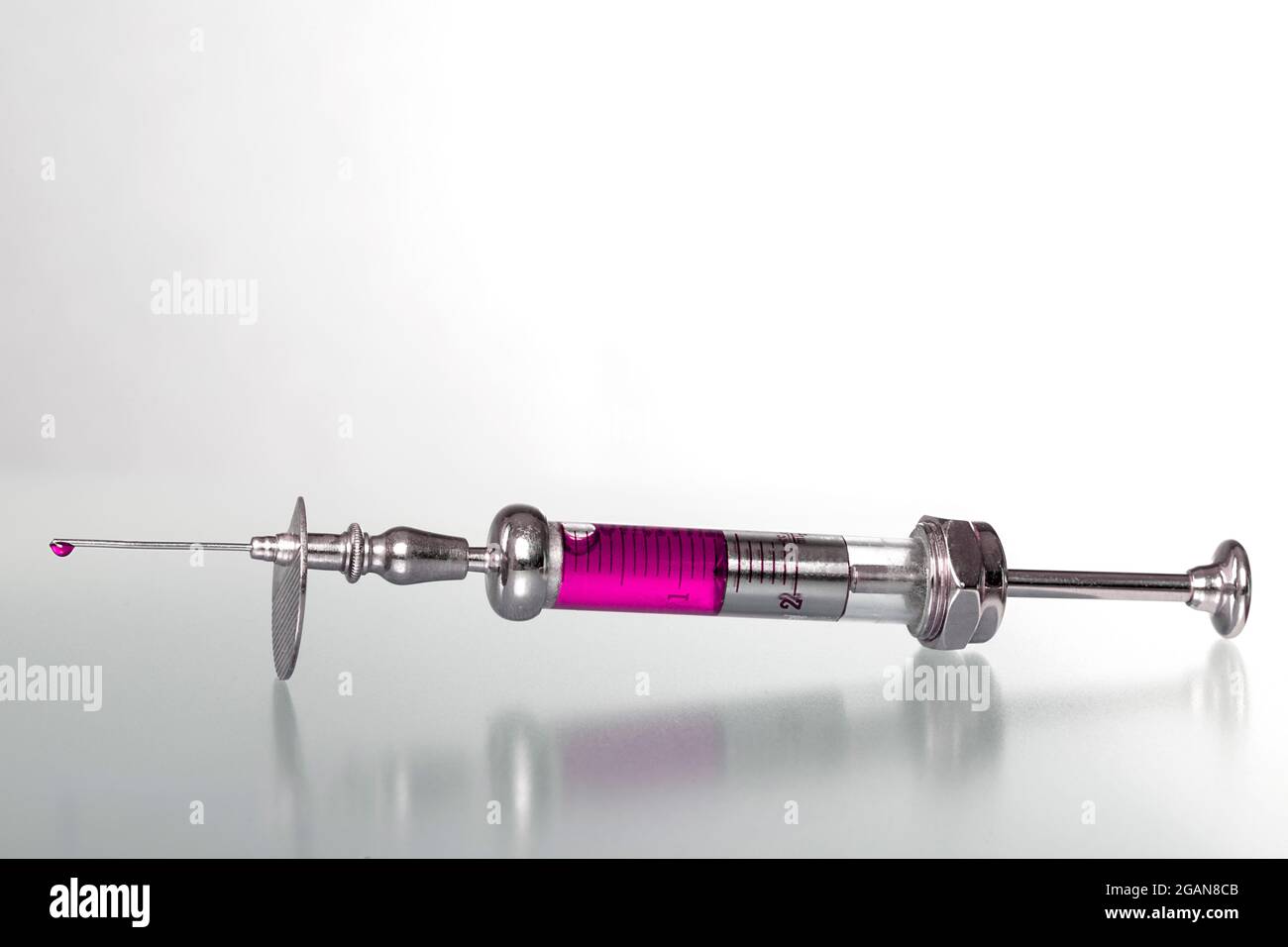 Studio shot of an old syringe filled with toxic looking liquid Stock ...