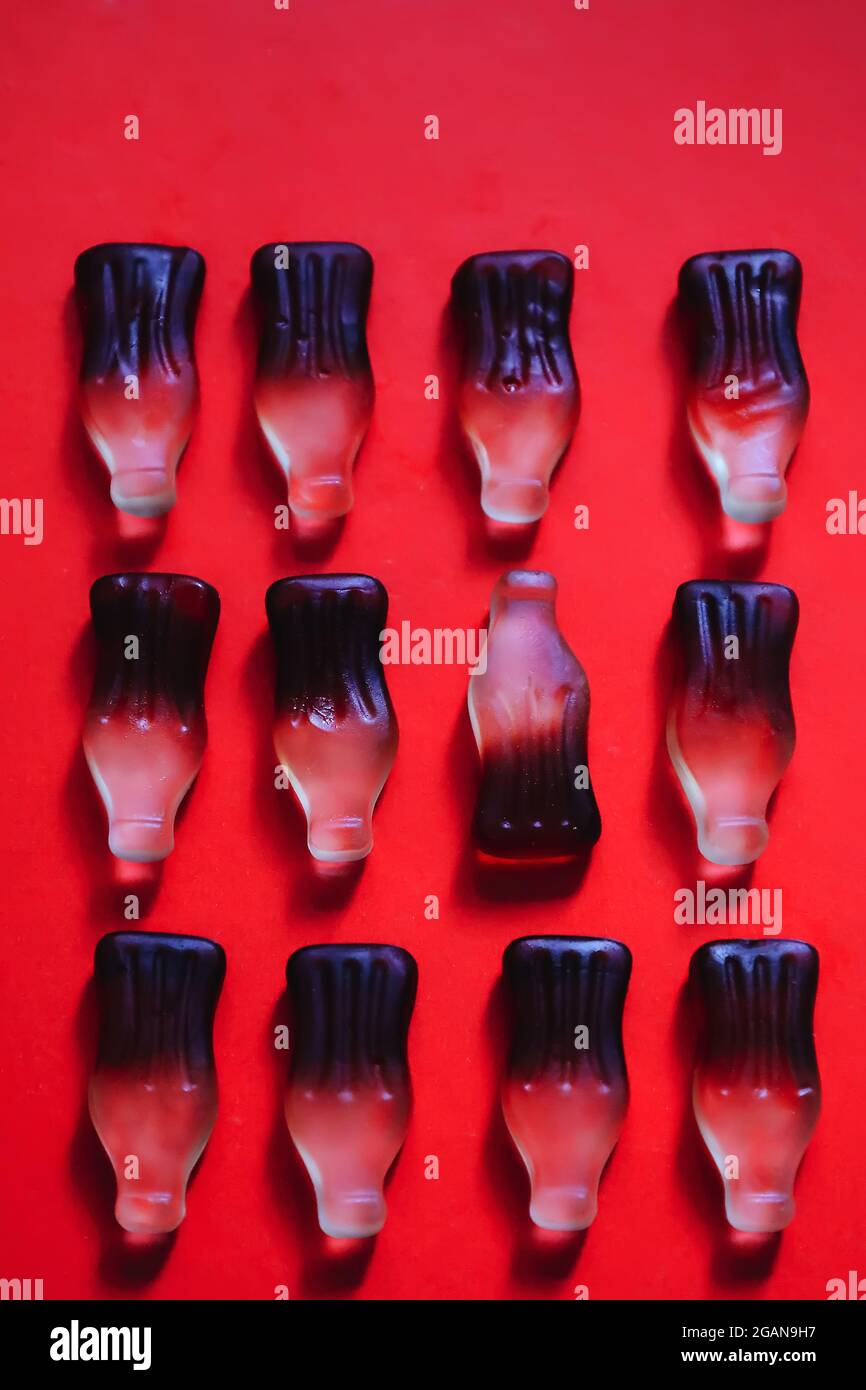 Cola gummy jelly in four rows, candies in bottle shape and flavour ...