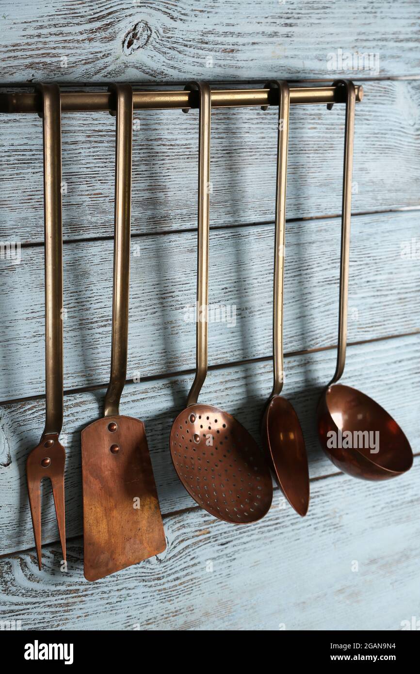 Kitchen utensil of scapula, spoons and fork on wooden background Stock ...