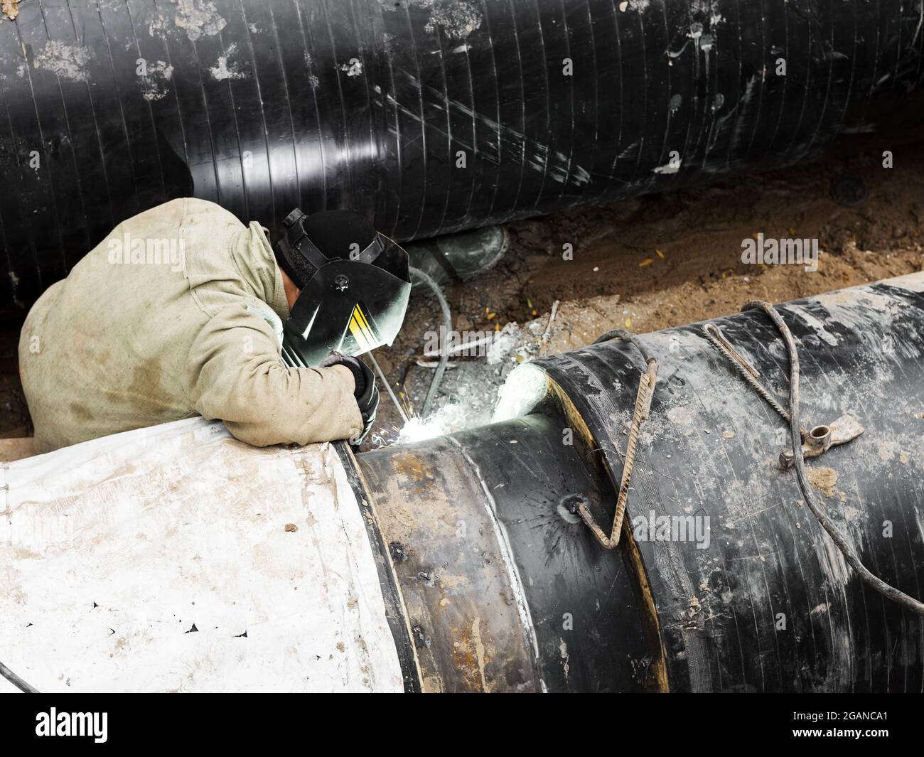 Repair of heating duct. The workers, welders made by electric welding ...