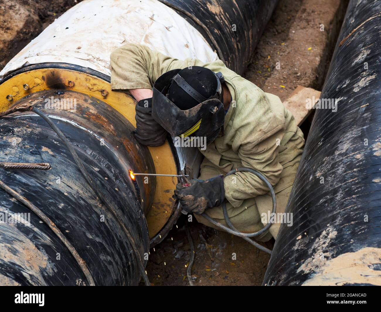 Repair of heating duct. The workers, welders made by electric welding ...