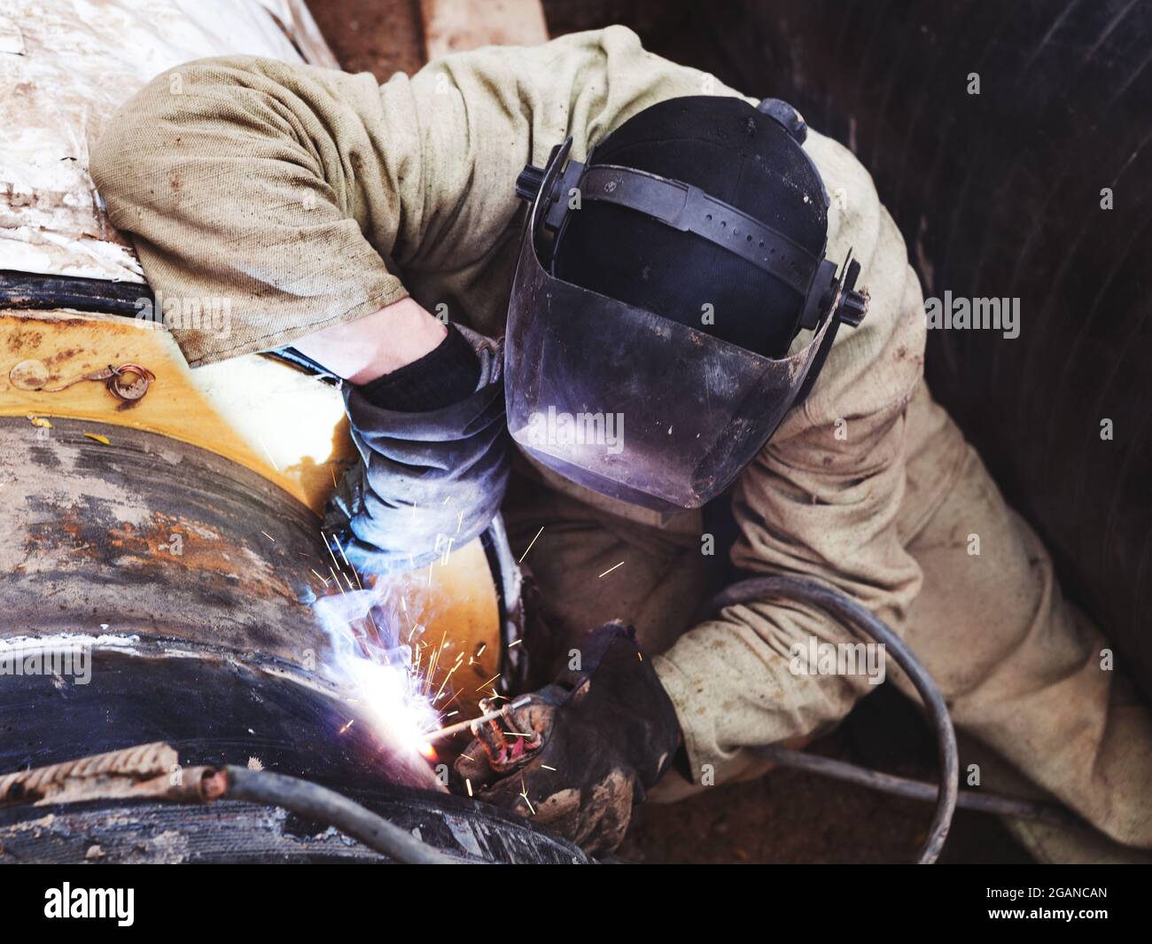 Repair of heating duct. The workers, welders made by electric welding ...