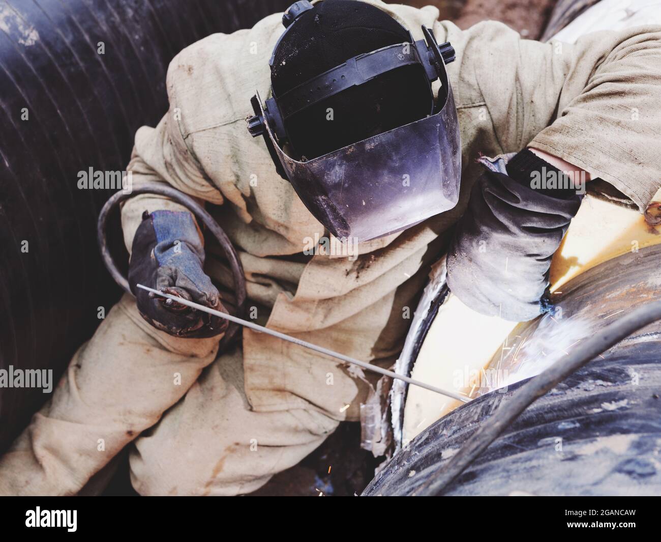 Repair of heating duct. The workers, welders made by electric welding ...