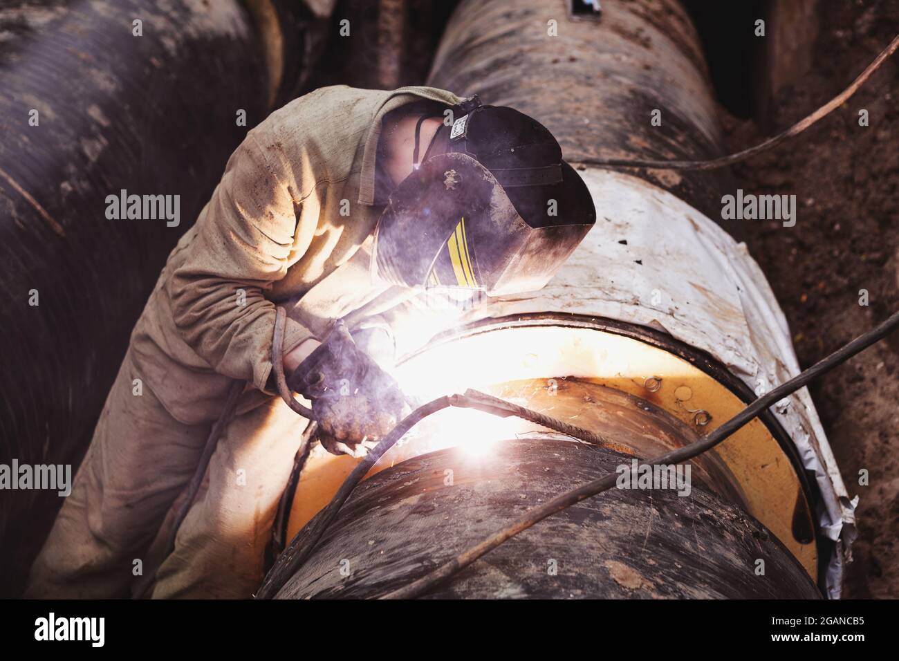 Repair of heating duct. The workers, welders made by electric welding ...