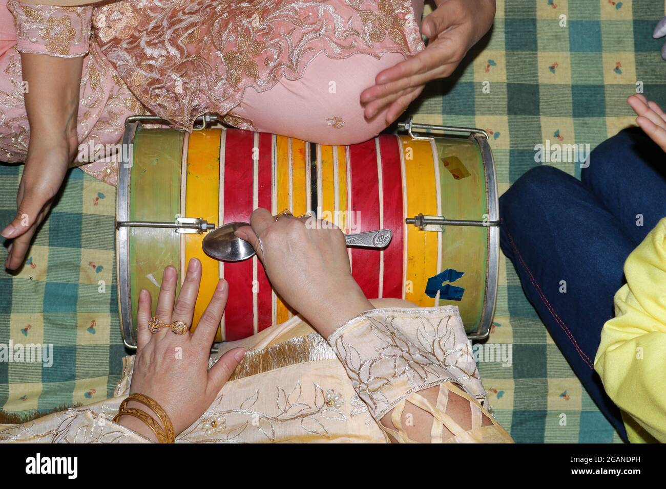 Top view shot of Two ladies playing with Double headed indian drum ...