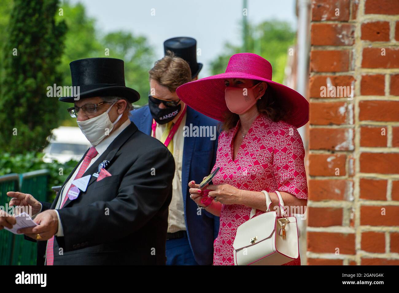 Ascot, Berkshire, UK. 16th June, 2021. A lady wears a large pink ...