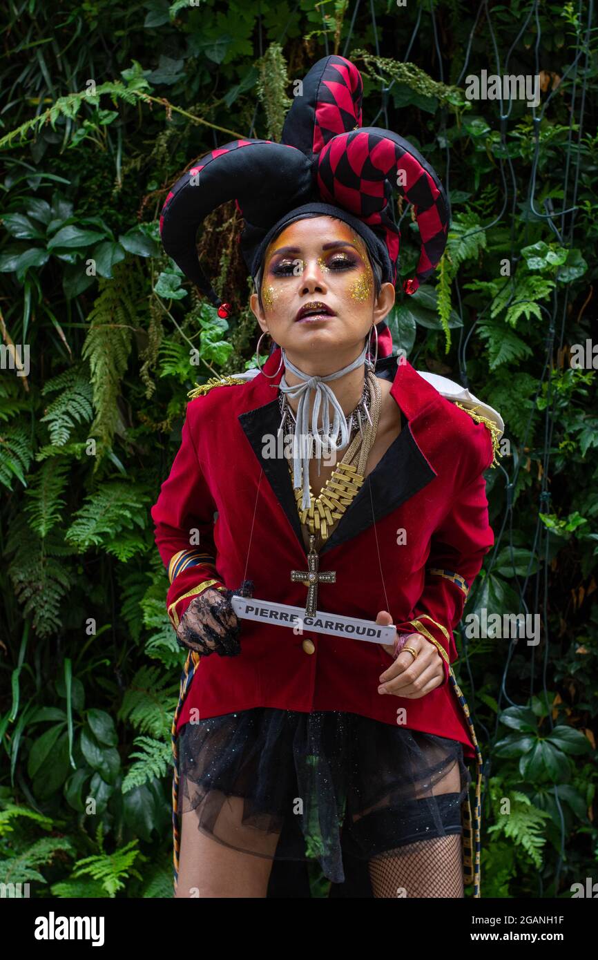 A model showcases Pierre Garroudi's latest colourful collection at one ...