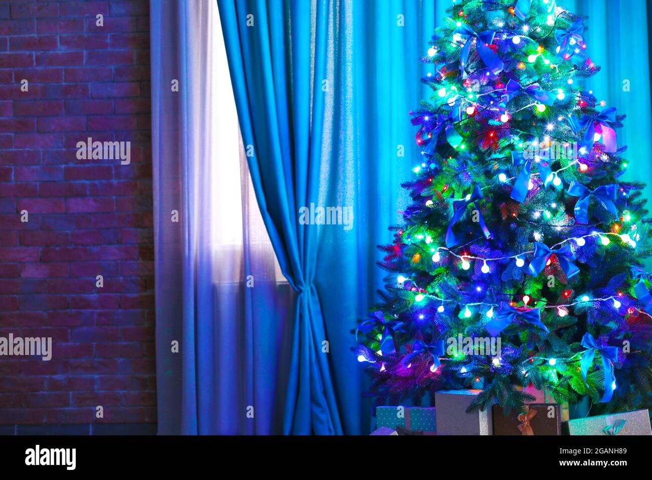 Christmas tree in a room on window background Stock Photo - Alamy