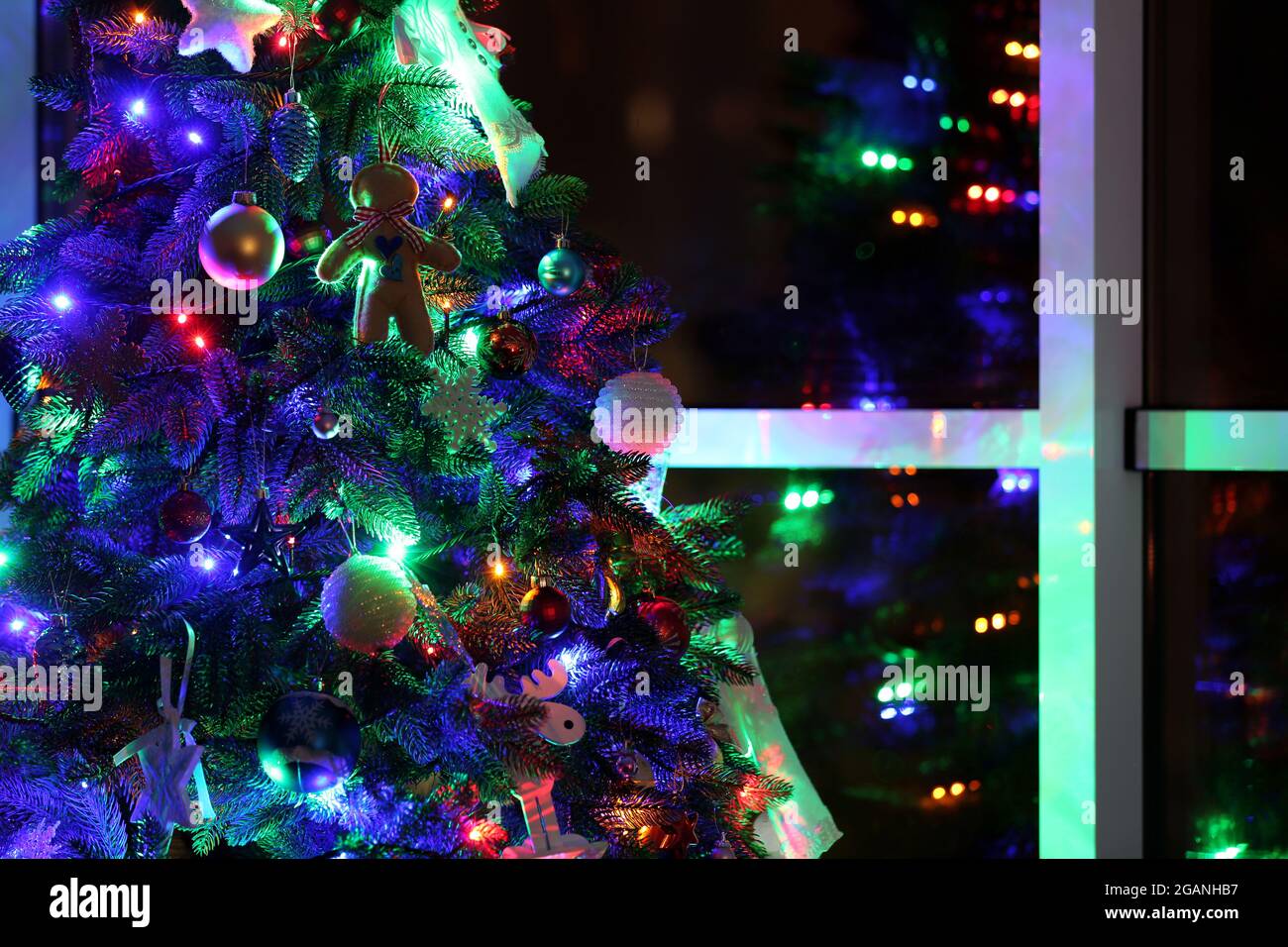 Christmas tree on window background Stock Photo - Alamy