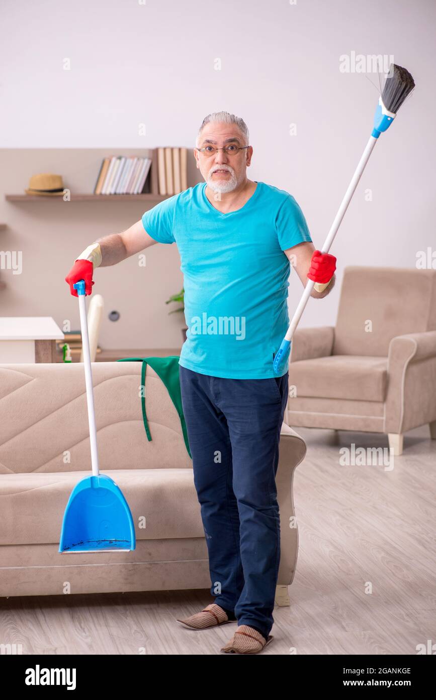 Aged man cleaning the house Stock Photo - Alamy