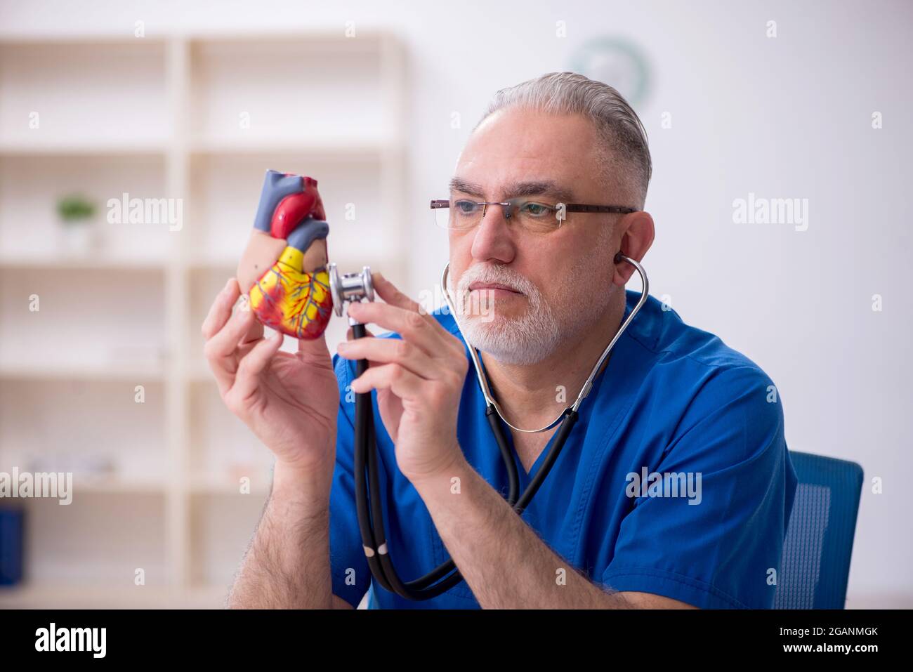 Experienced male doctor cardiologist working in the clinic Stock Photo ...
