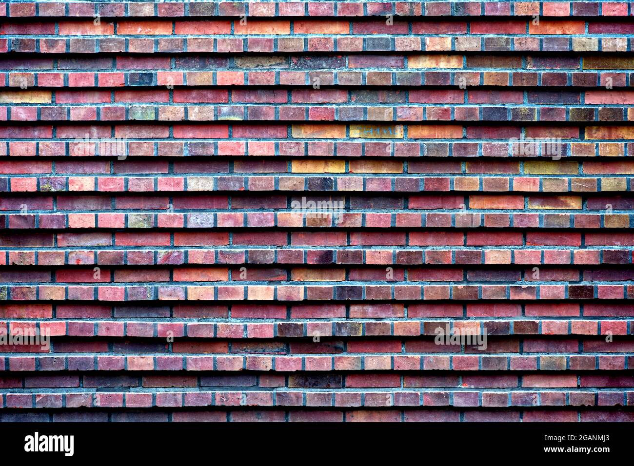 Vintage brick wall; multi-colored red bricks, textured background ...