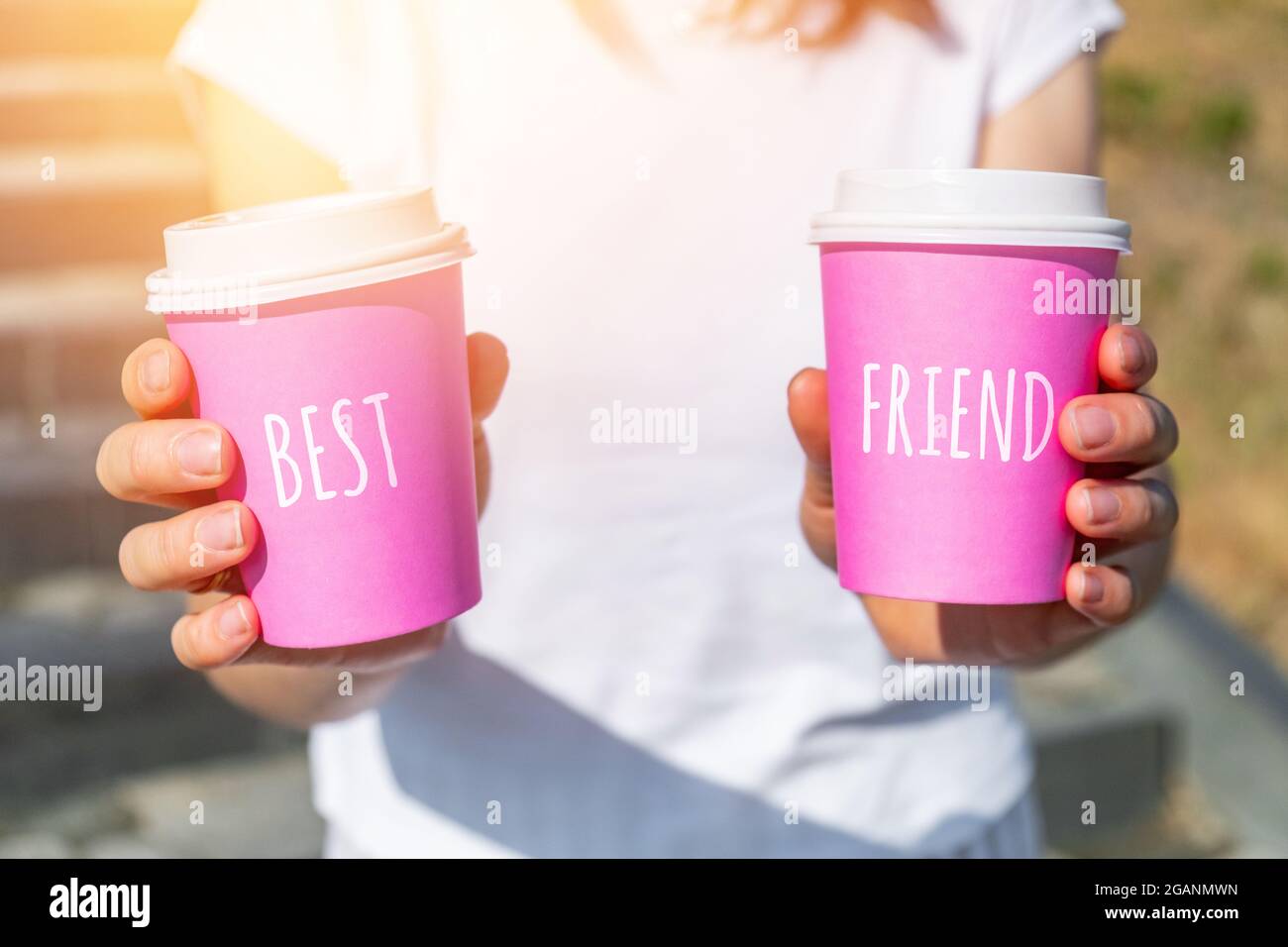 Person holding two pink disposable cups with best friend concept Stock ...