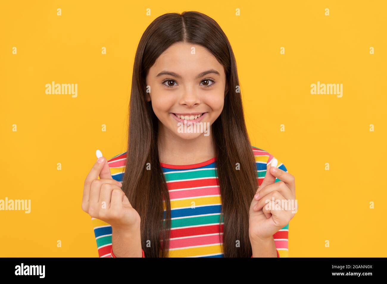 happy child presenting natural food additives or vitamin pills, healthy ...