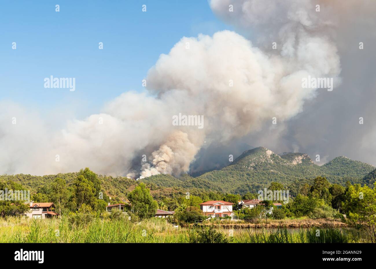 Smoke from a forest fire rising over Hisaronu neighbourhood of Marmaris ...