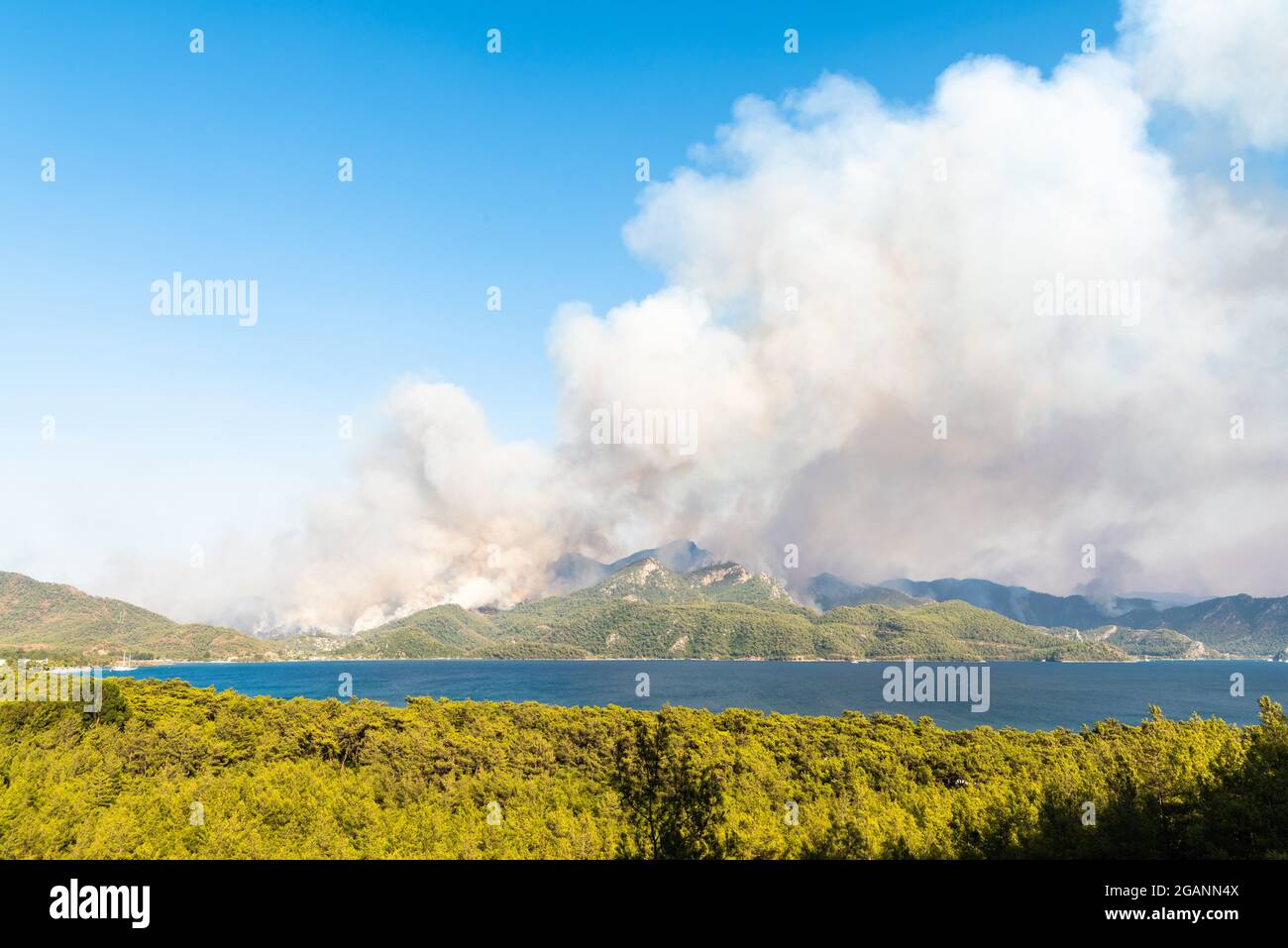 Smoke from a forest fire rising over Hisaronu bay and neighbourhood of ...