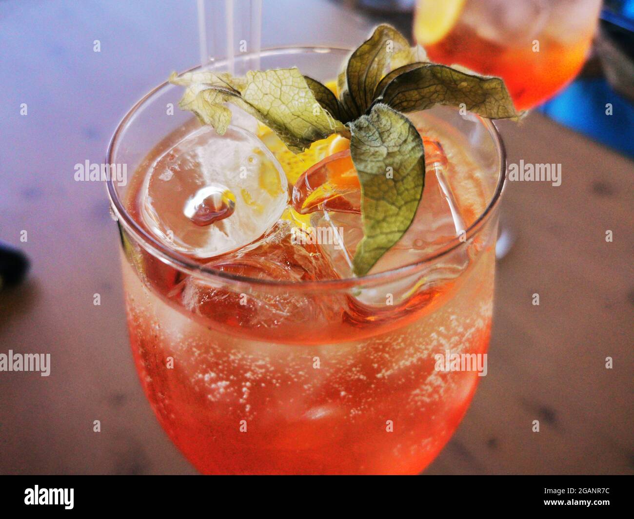 High angle shot of a fresh cocktail with ice and herb leaves in a glass ...