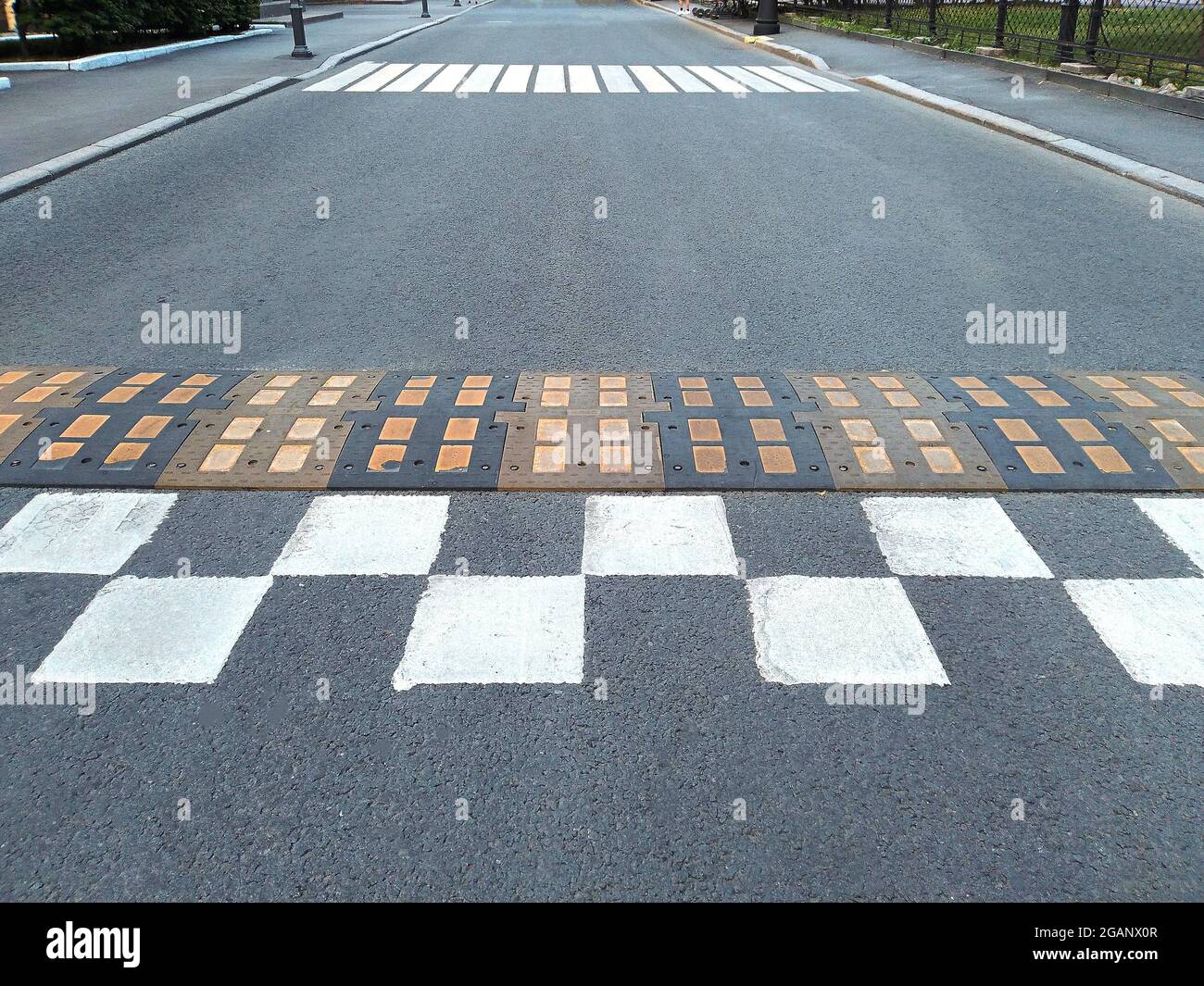 A speed bump on the city road, asphalt barrier, safety obstacle before ...
