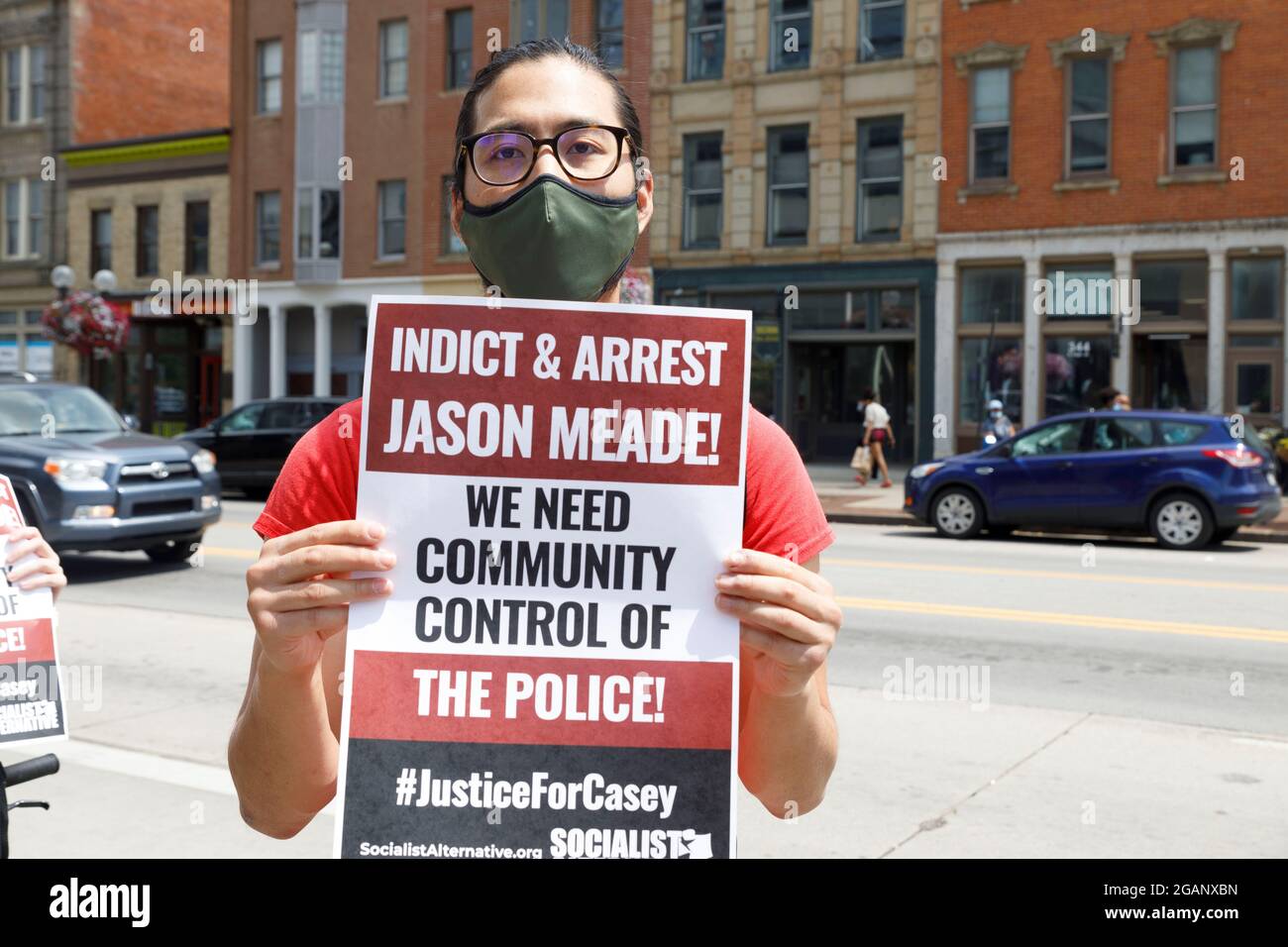 A protester holds a placard advocating for Jason Meade to be indicted ...