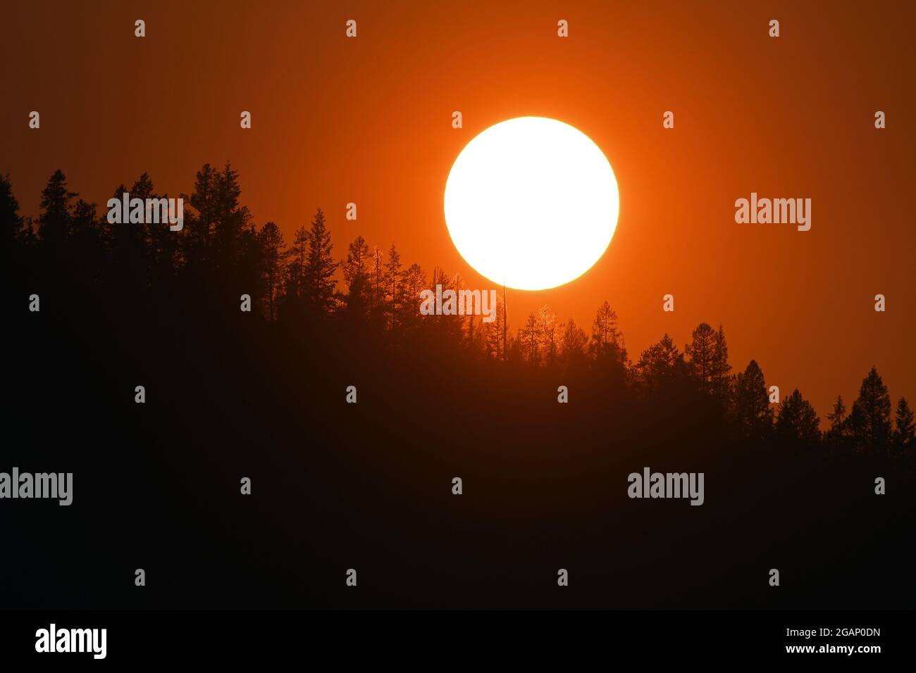 Sun setting behind the Purcell Mountains and wildfire smoke during 2021 ...