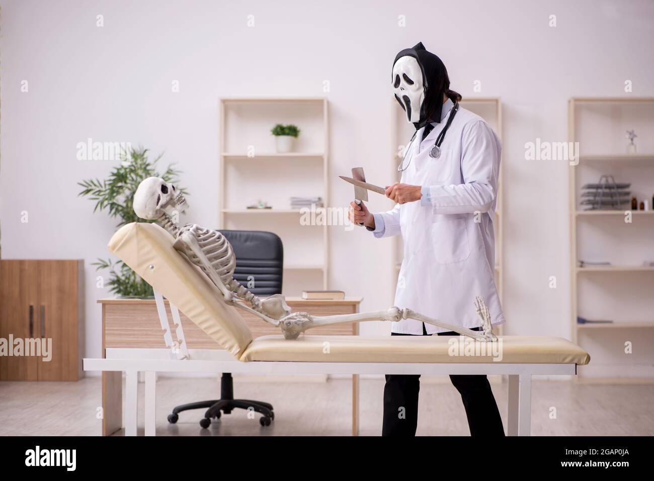 Devil doctor examining skeleton patient in the clinic Stock Photo - Alamy