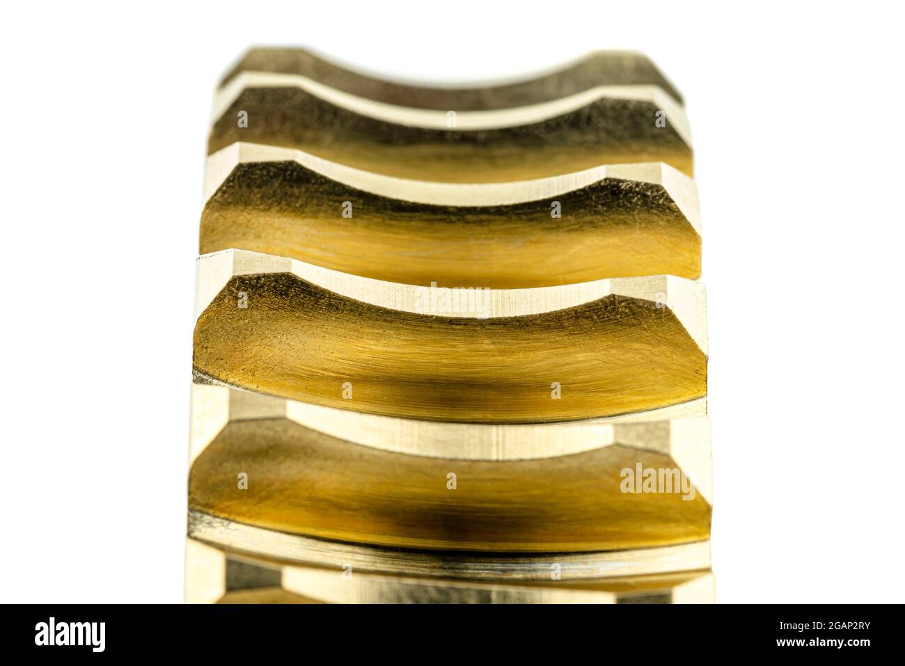 A macro photo of a new shiny copper gear, isolated on a white ...