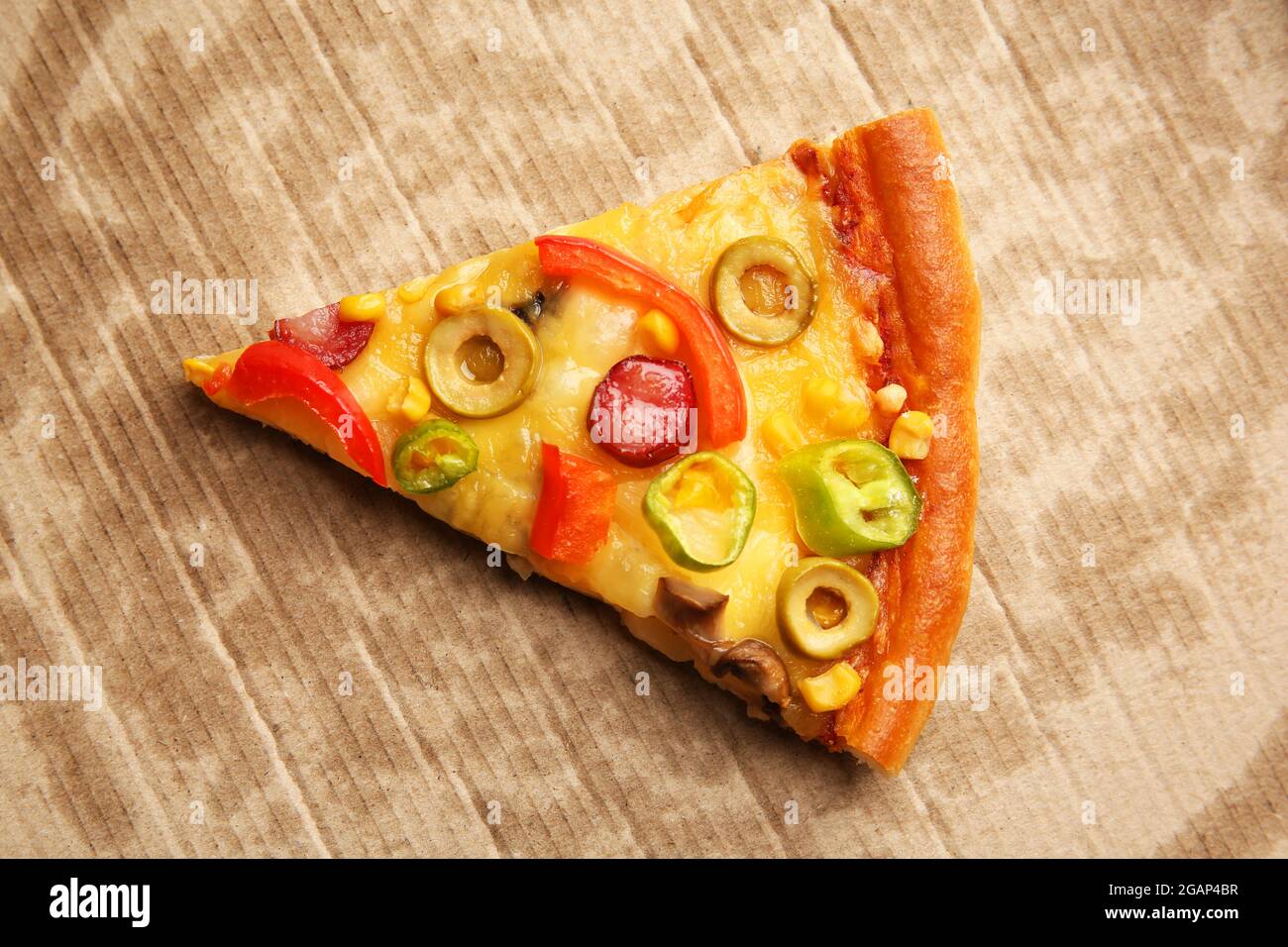Slice of delicious pizza on cardboard Stock Photo - Alamy