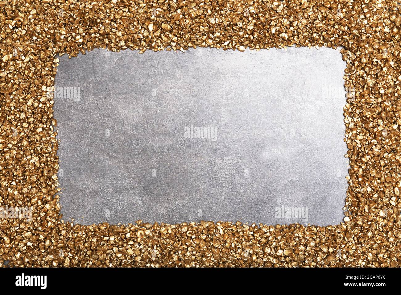 A frame of Gold nugget grains, on cement background Stock Photo - Alamy